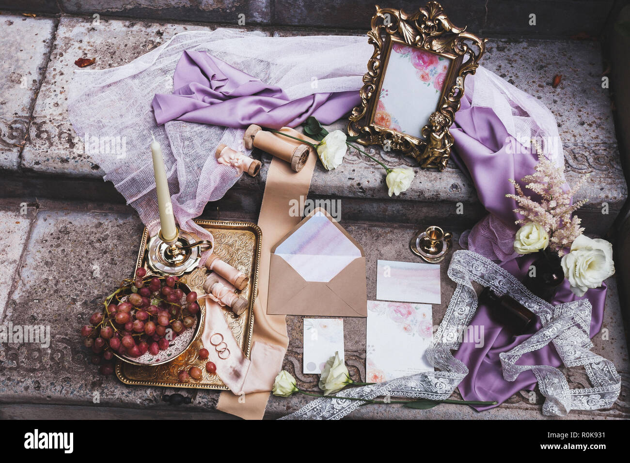 Beautiful wedding details with fresh grape, silk, frame and invitation ...