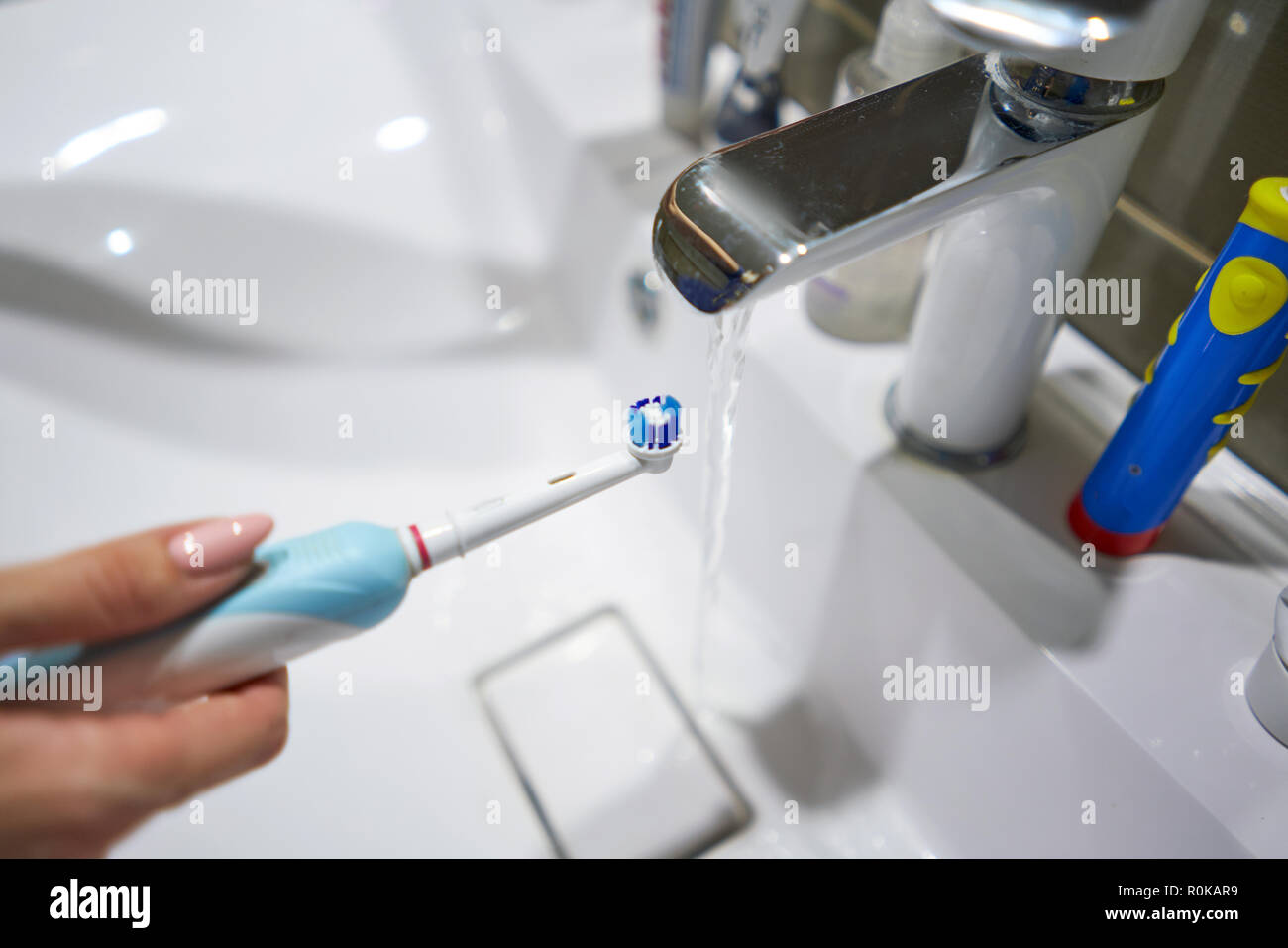 toothbrush and tube in hand Stock Photo - Alamy