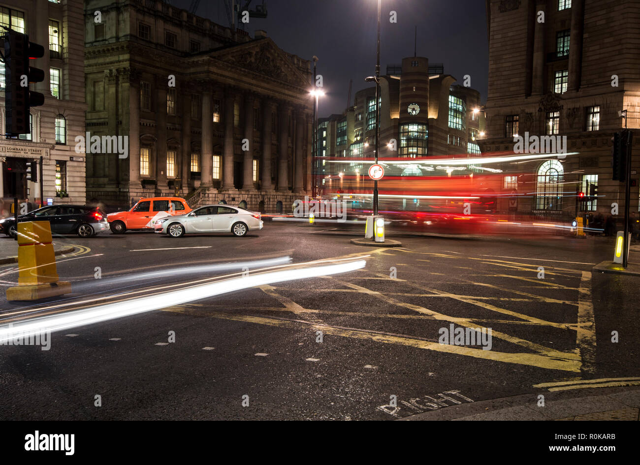 Red London buses at night near the Bank of England in the City of ...