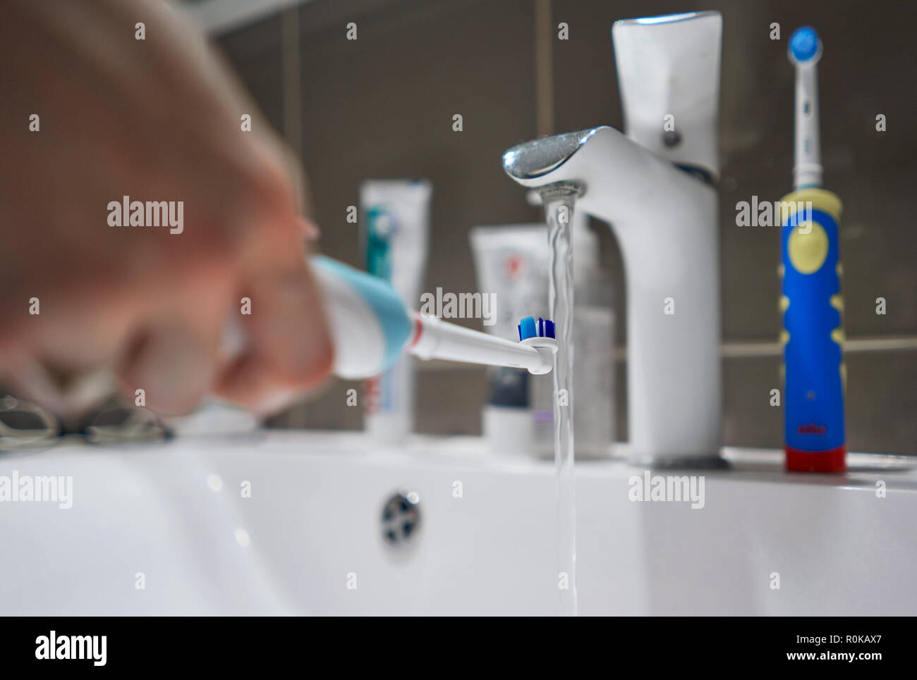 toothbrush and tube in hand Stock Photo - Alamy