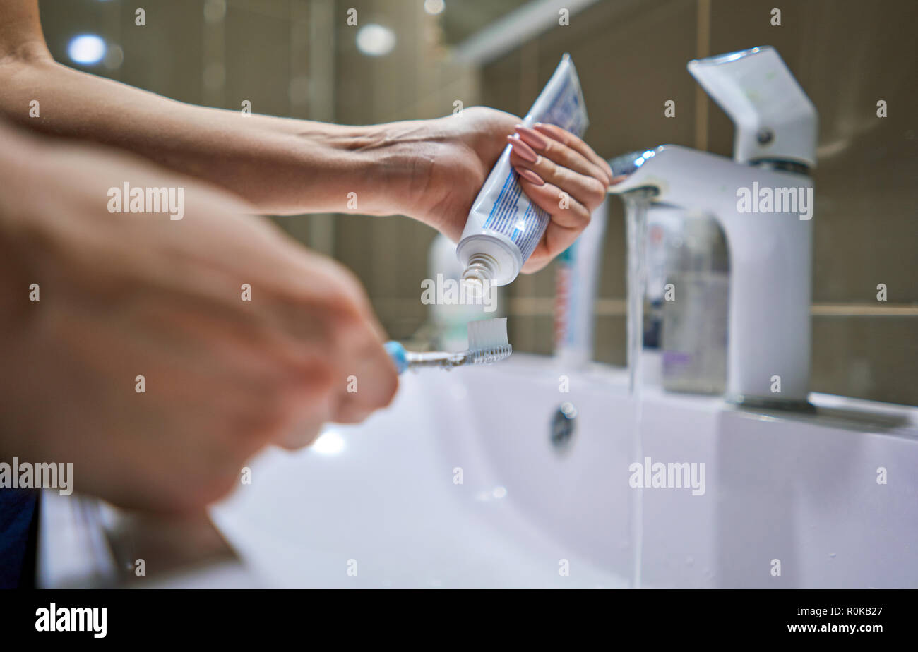 toothbrush and tube in hand Stock Photo - Alamy