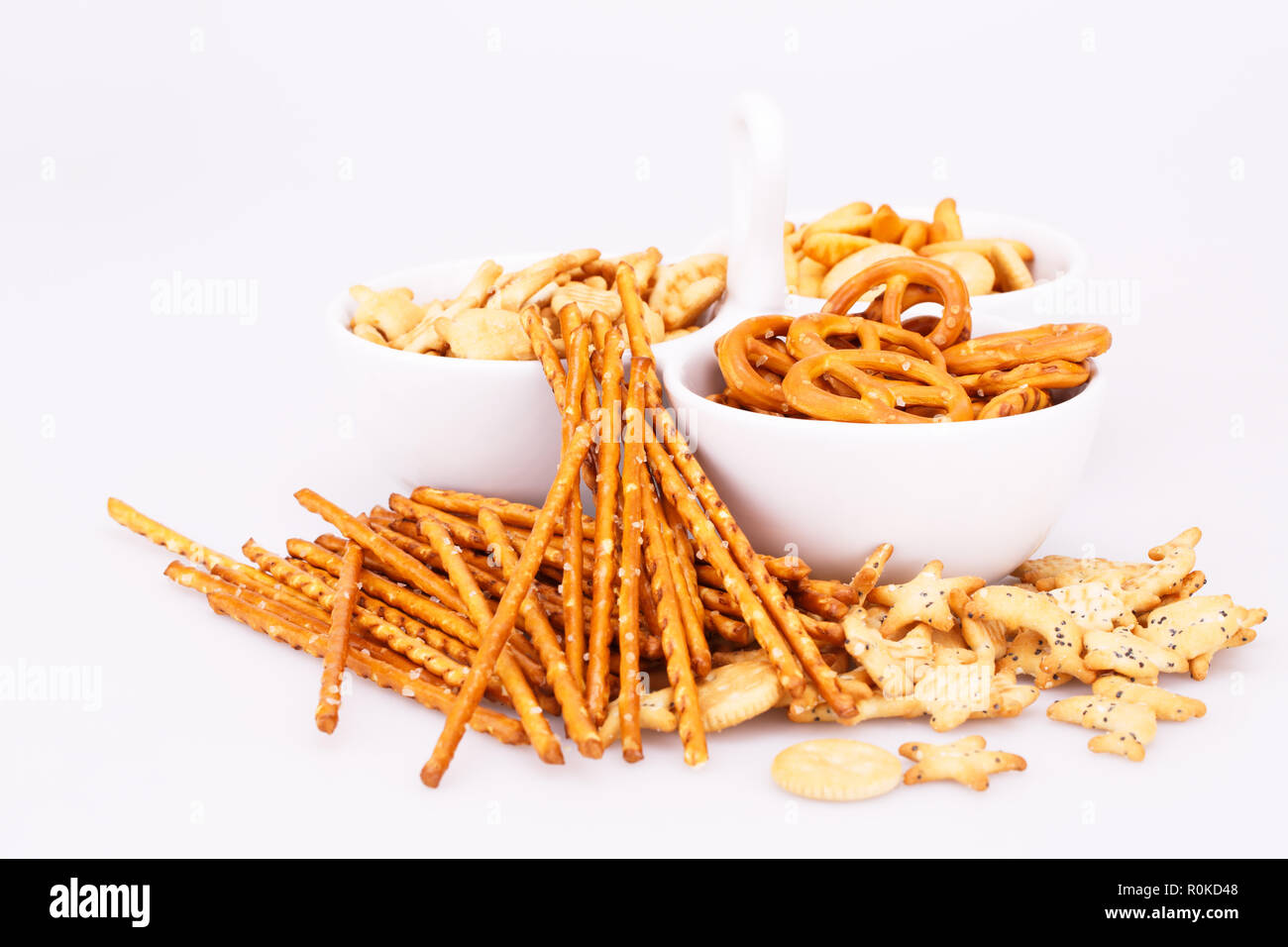 Different salted crackers in bowl isolated on white background Stock ...