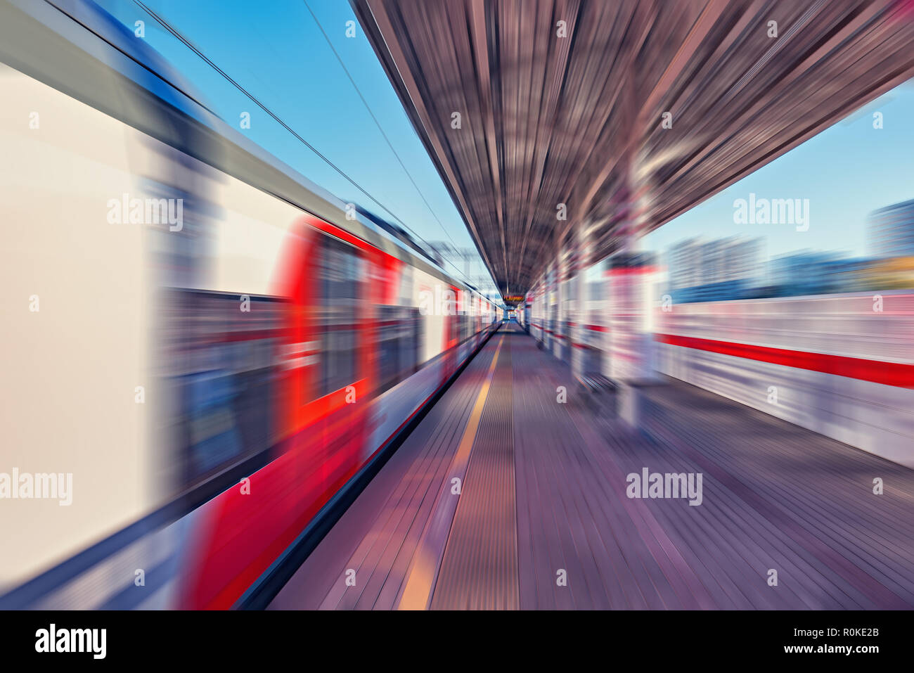 Modern high-speed train moves fast along the platform Stock Photo - Alamy