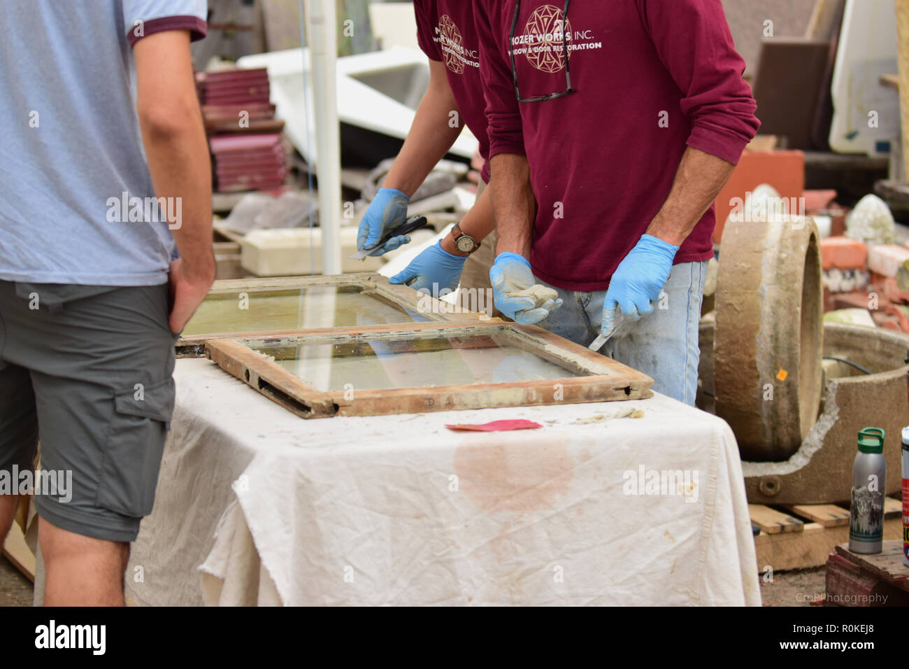 Staff at Reuse Center demonstrating how to replace window glass Stock ...