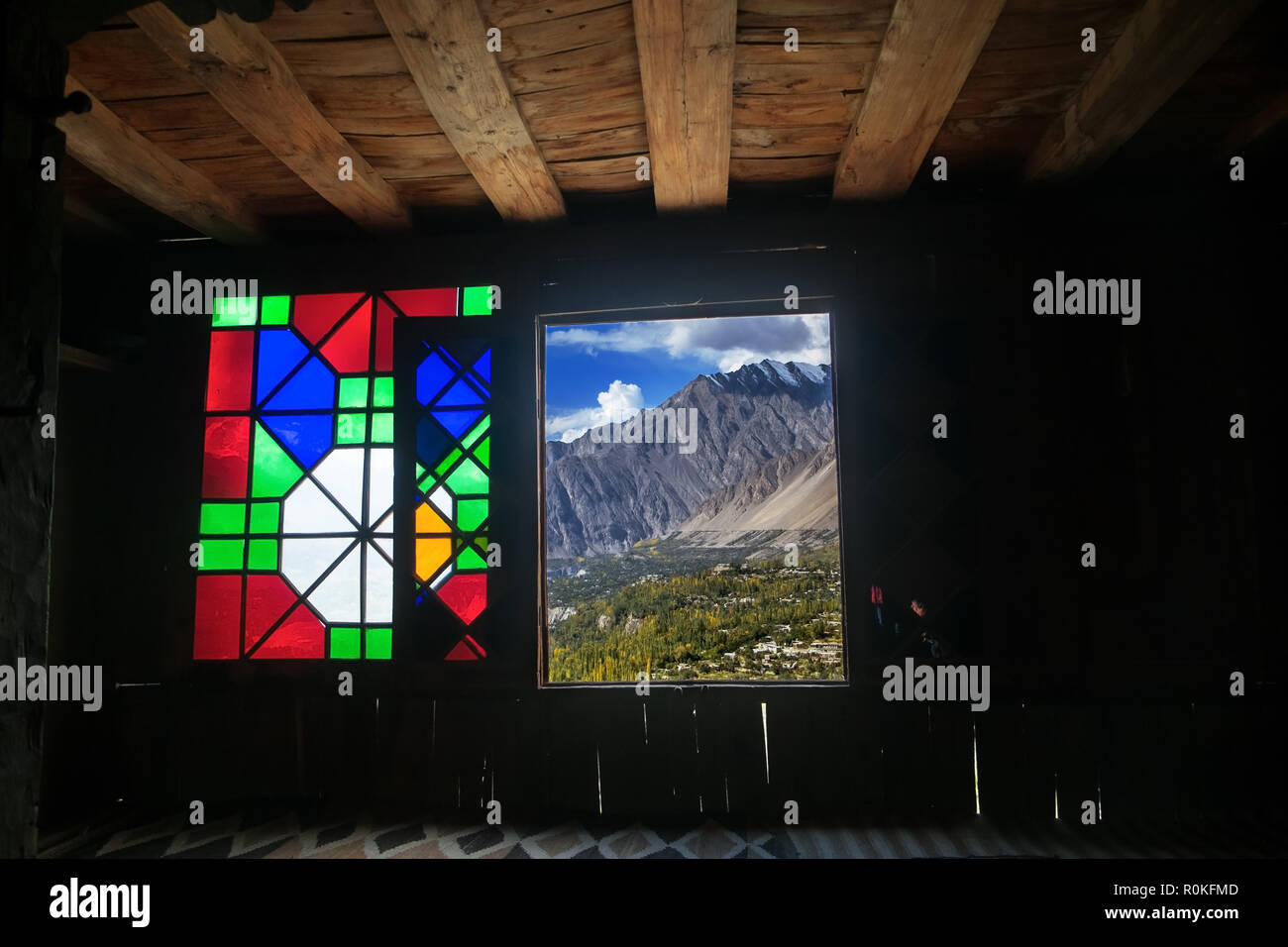 An autumn view of Hunza valley through a window in Baltit fort. Gilgit ...