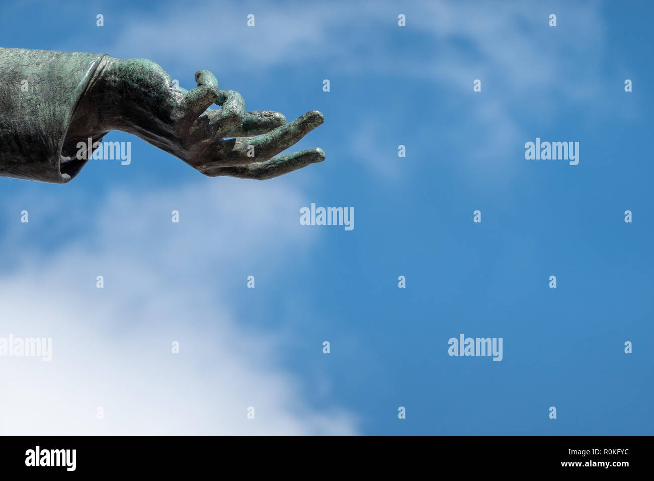 Hand of a bronze statue, open to show the will to peace Stock Photo - Alamy