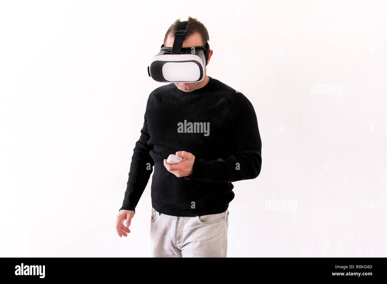 Handsome man wearing and playing virtual reality on isolated white ...