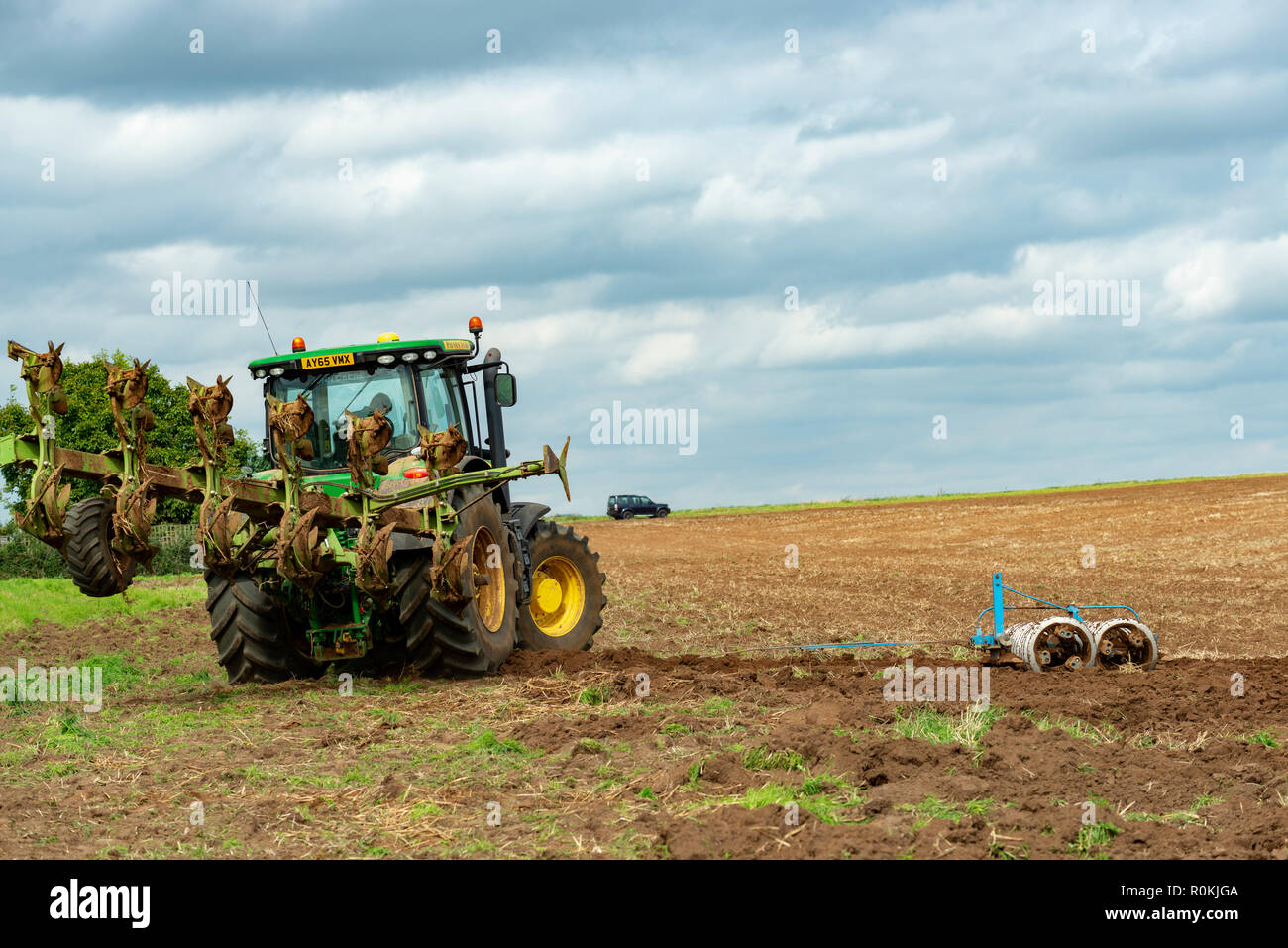 John Deere tractor and plough, Bawdsey, Suffolk, England Stock Photo ...