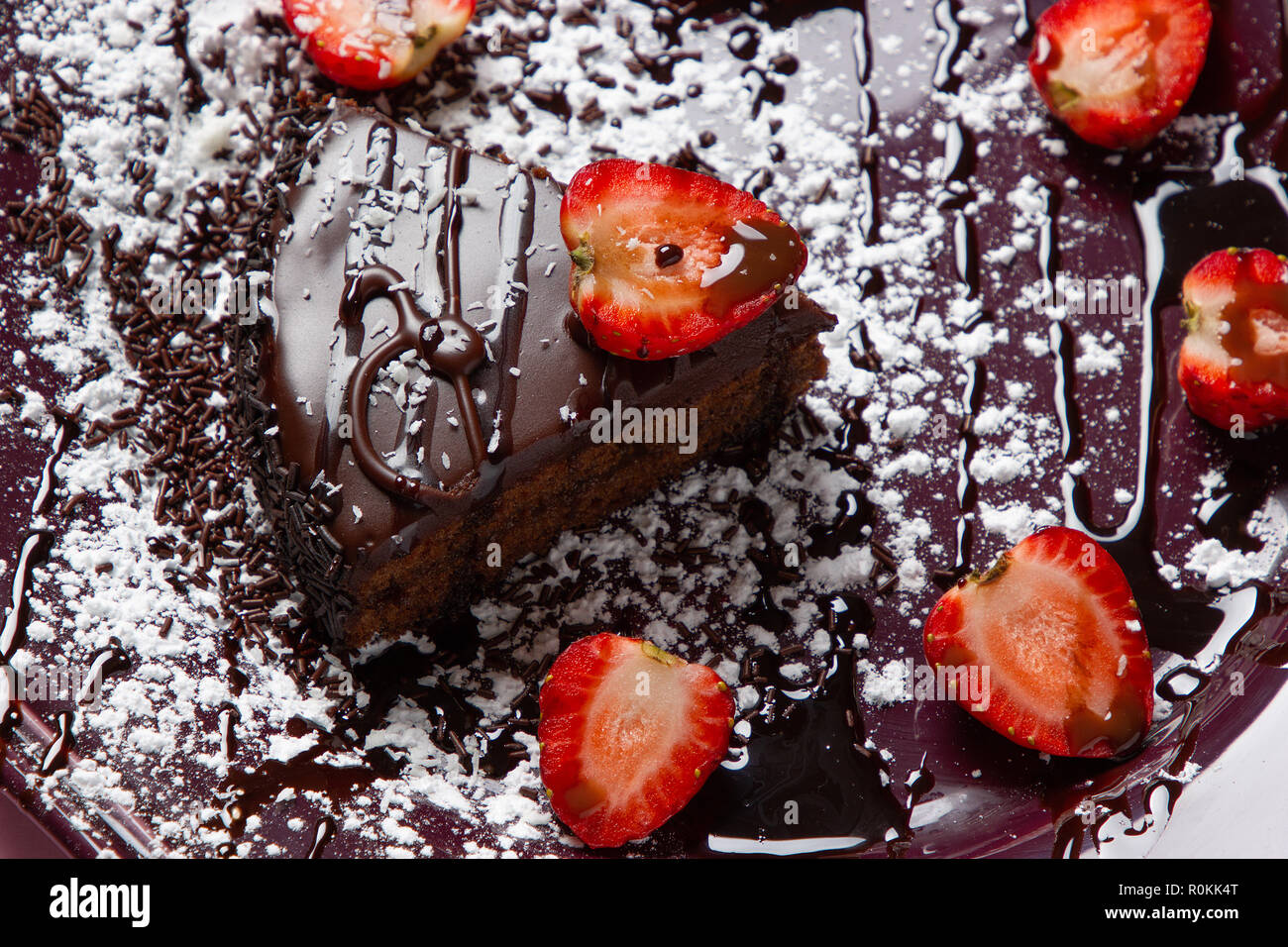a delicious slice of Viennese chocolate sacher cake with strawberries ...
