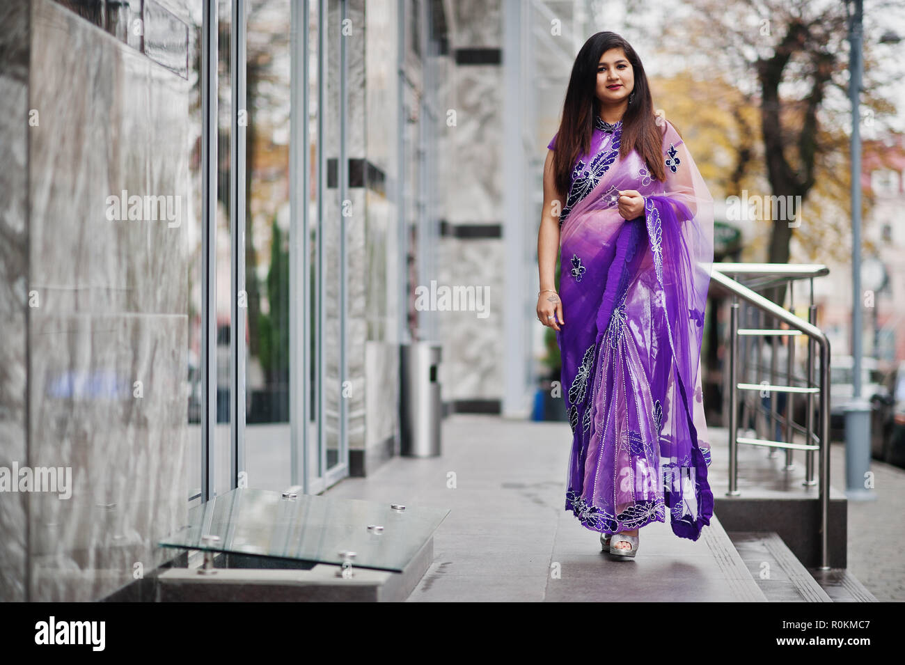 Indian hindu girl at traditional violet saree posed at street Stock ...