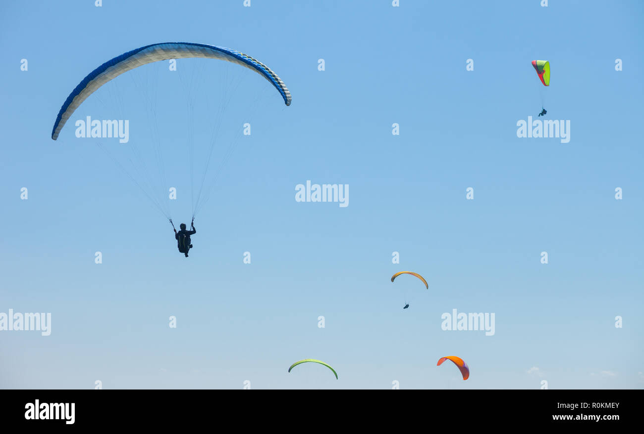 A large group of paragliders enjoy a thermal updraft in the Nepal ...
