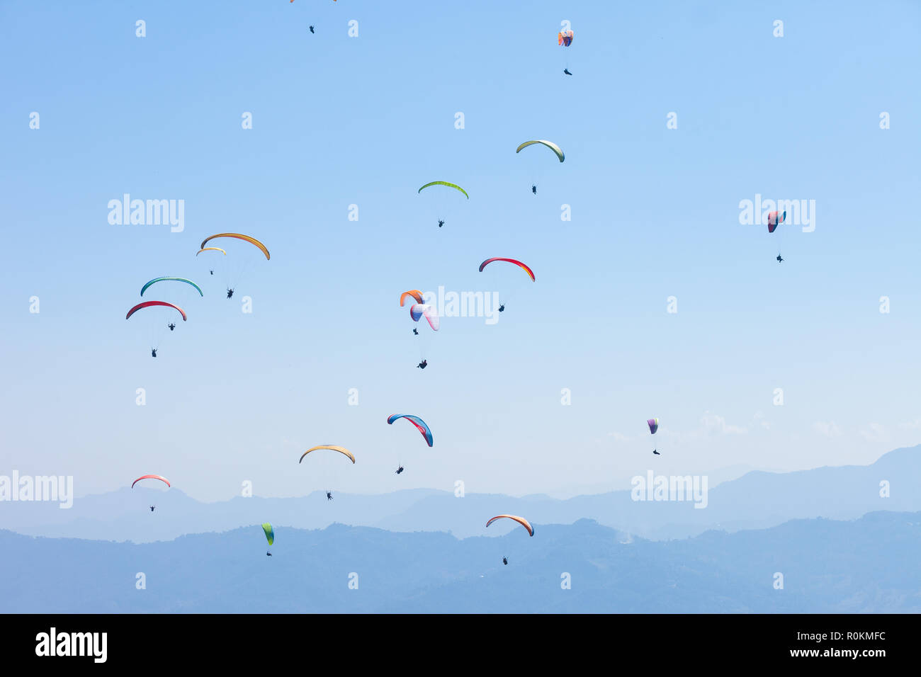 A large group of paragliders enjoy a thermal updraft in the Nepal ...