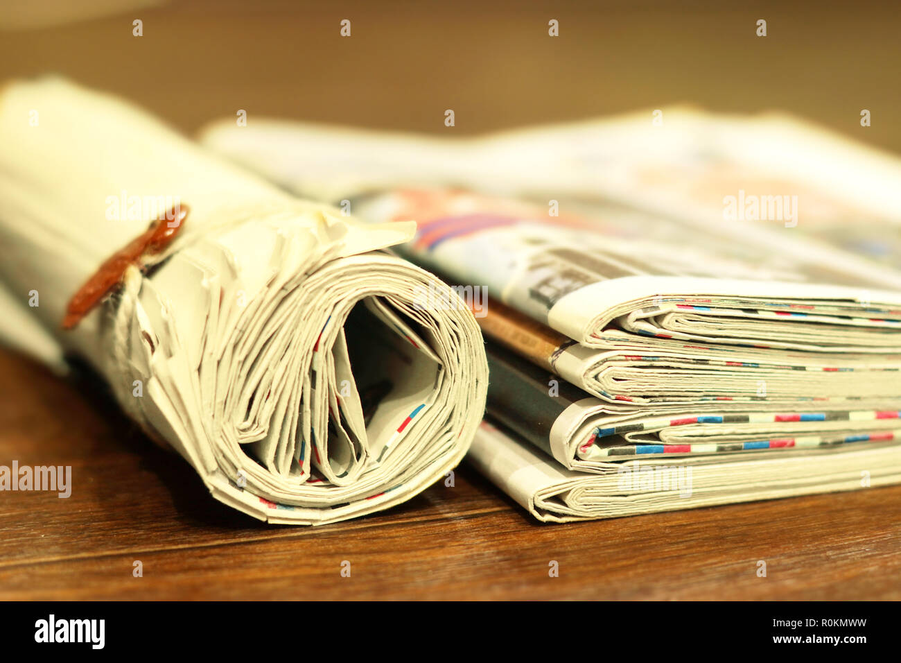Newspapers folded and rolled, side view Stock Photo - Alamy