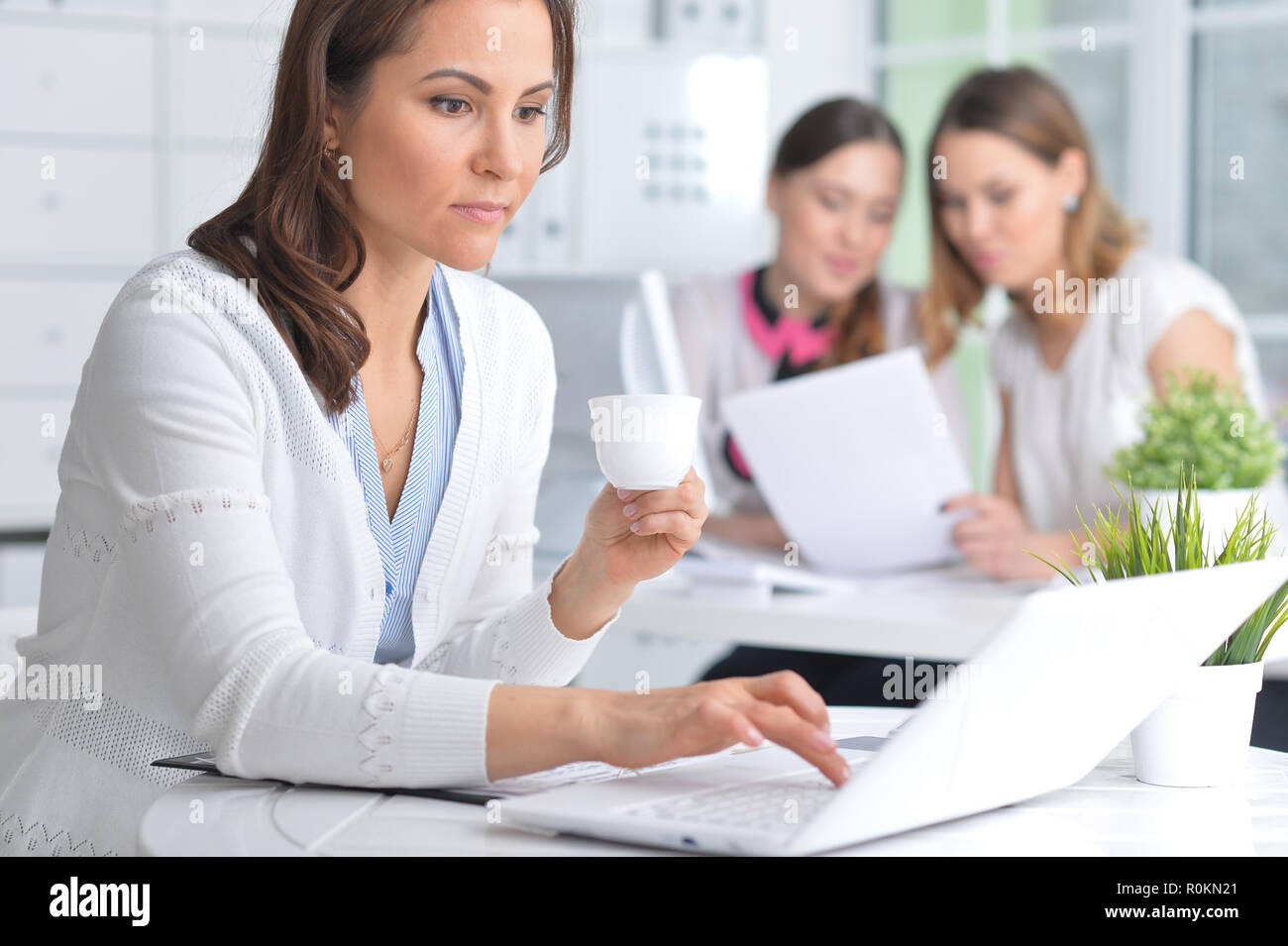 Portrait of young women working in modern office Stock Photo - Alamy