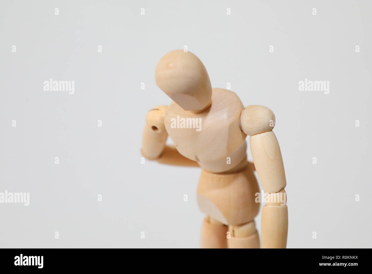 Wooden doll posing back pain Stock Photo - Alamy