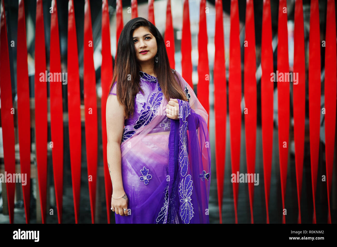 Indian hindu girl at traditional violet saree posed at street against ...