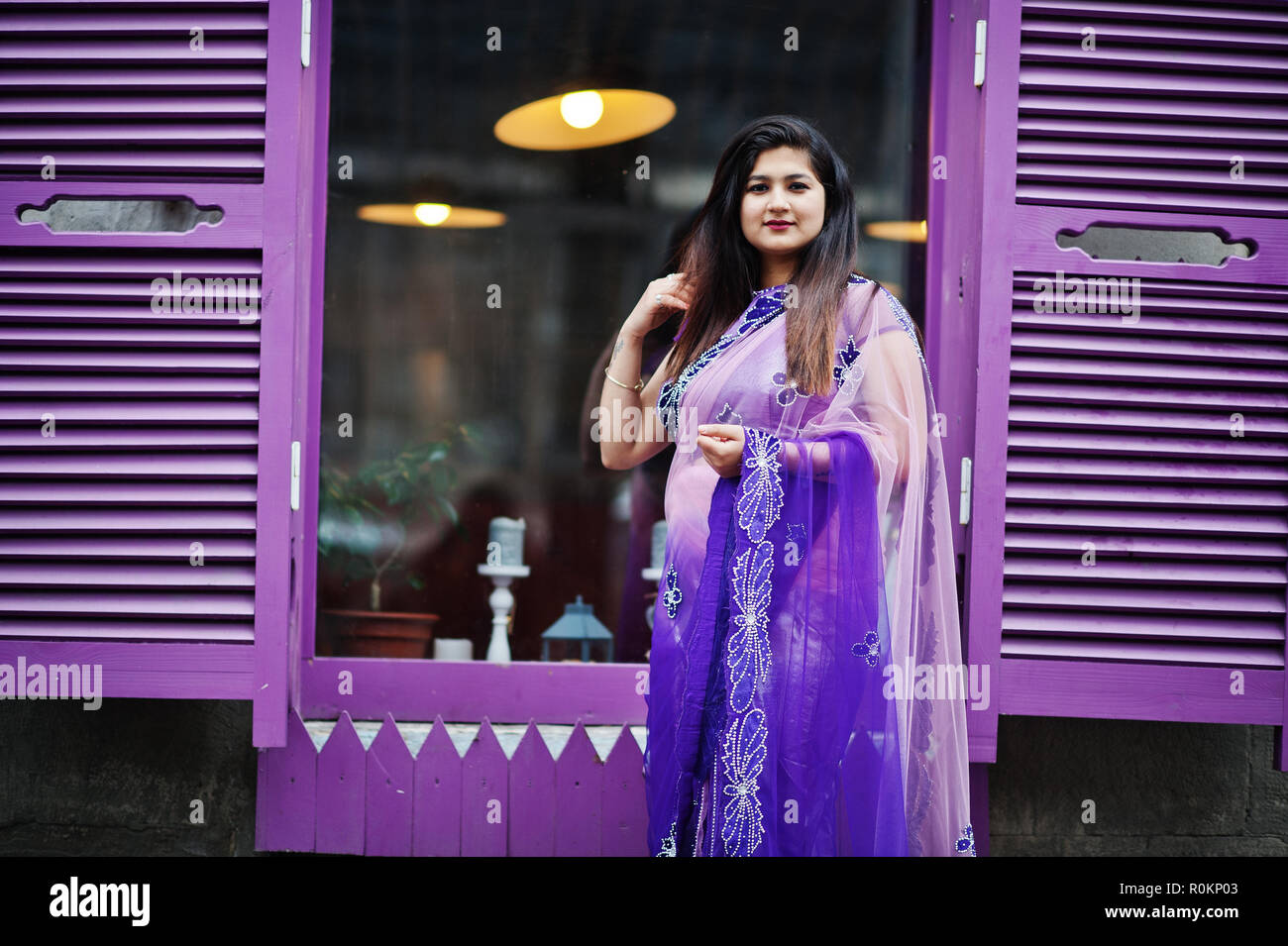 Indian hindu girl at traditional violet saree posed at street against ...