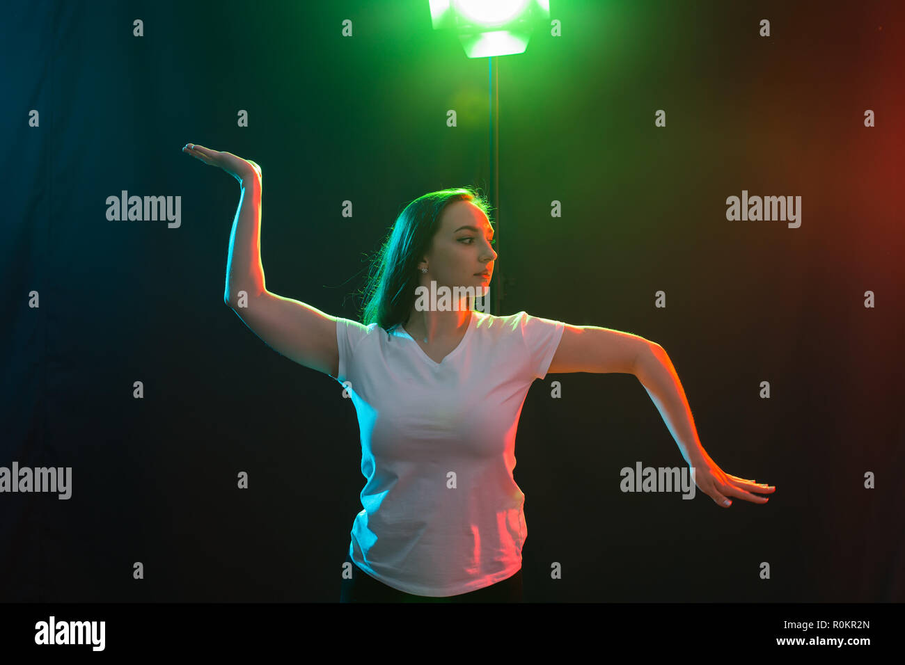 People and dancing concept - Young fitness woman dancing jazz funk over ...