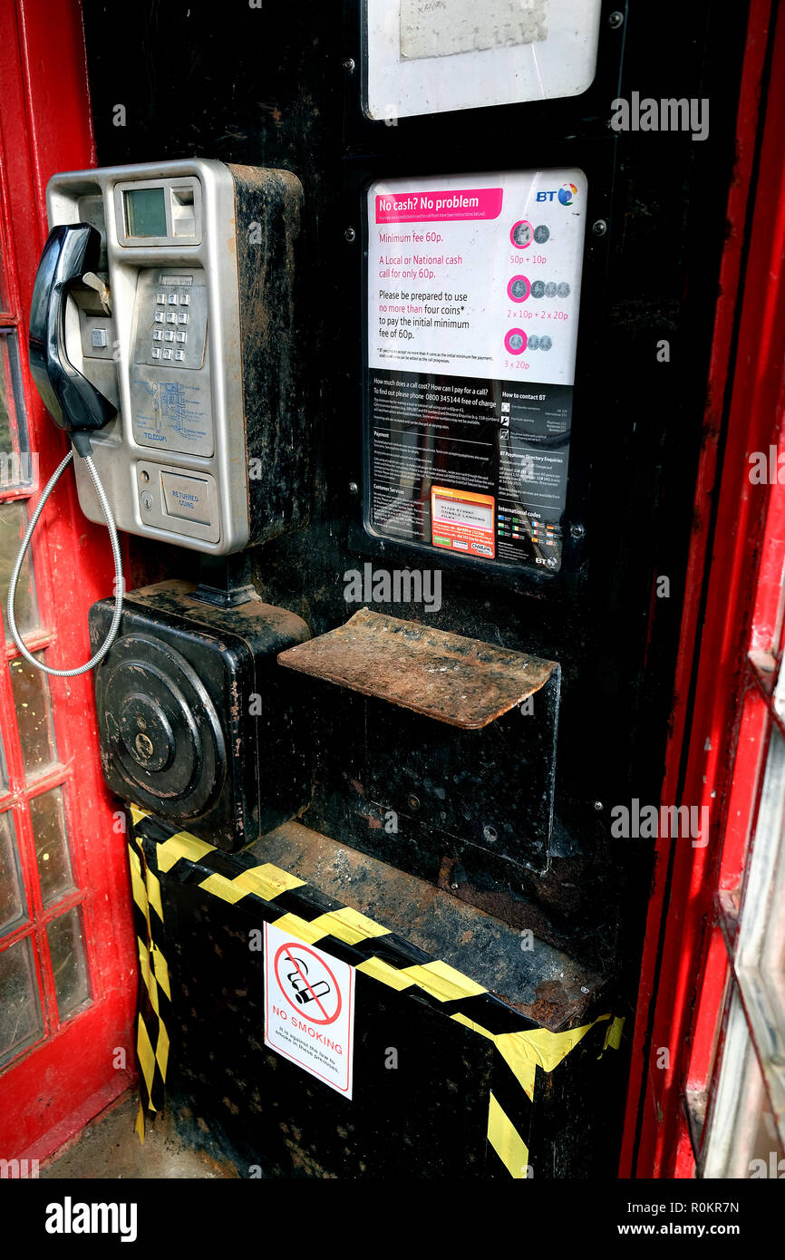 Old UK telephone box with equipment in poor state of repair Stock Photo ...