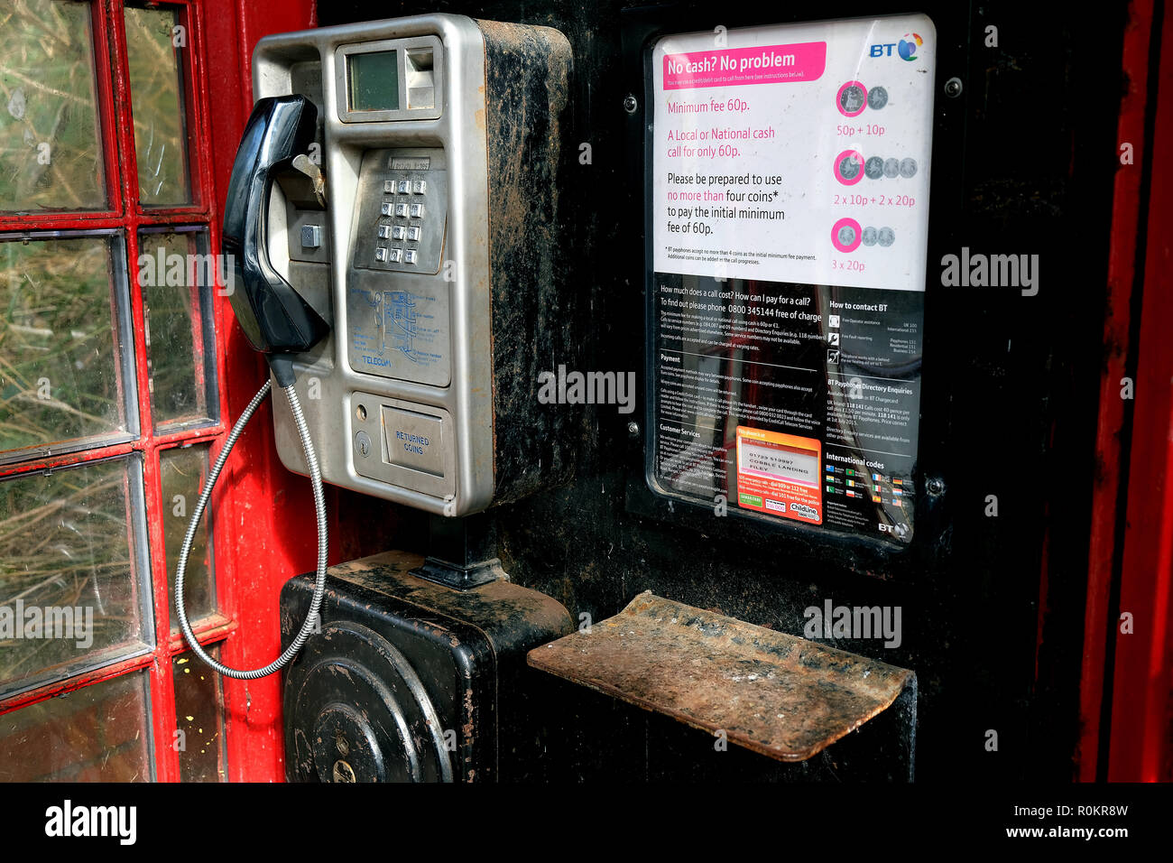 Old UK telephone box with equipment in poor state of repair Stock Photo ...