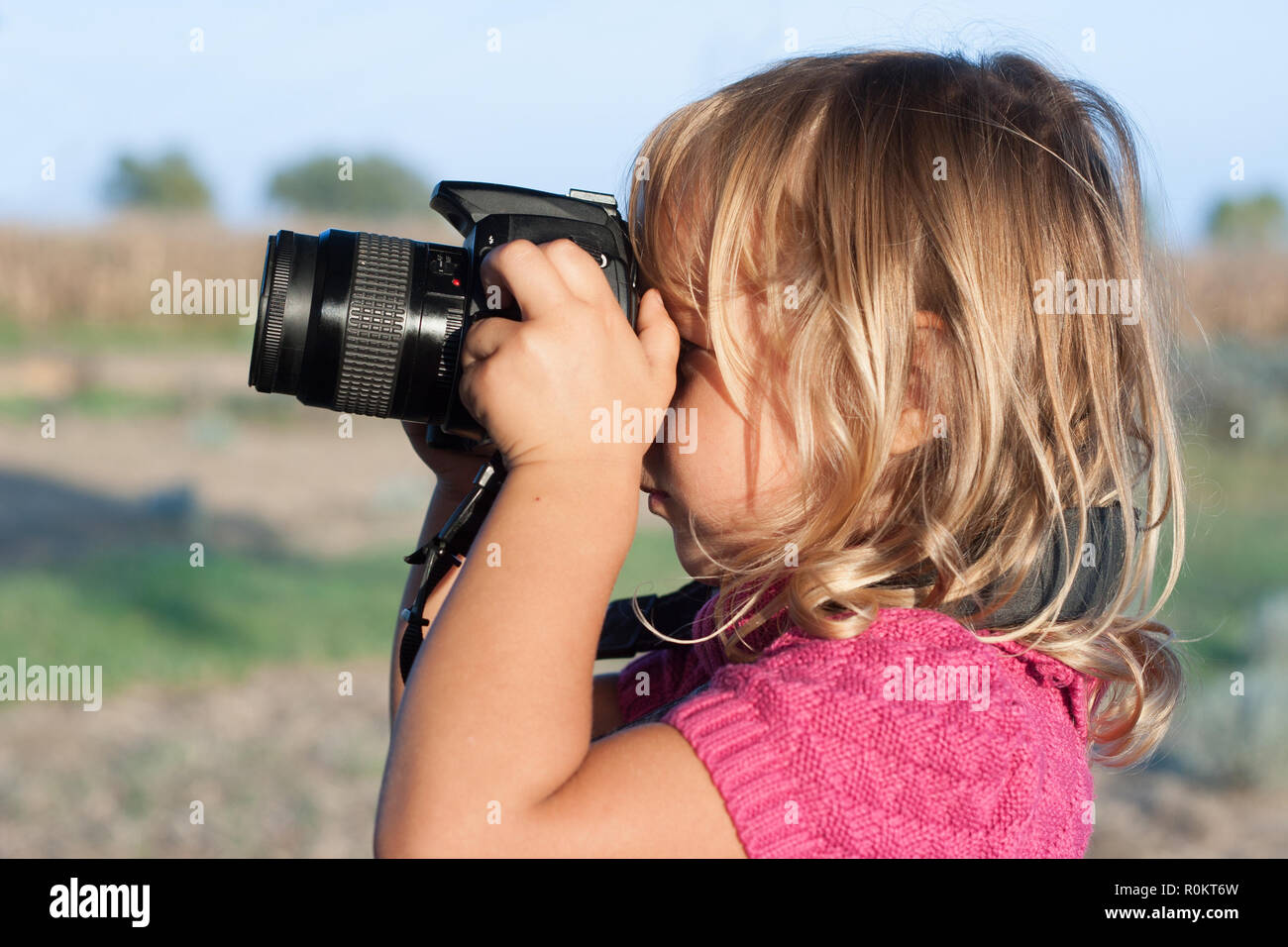 Portrait of a child holding a photo camera Stock Photo - Alamy