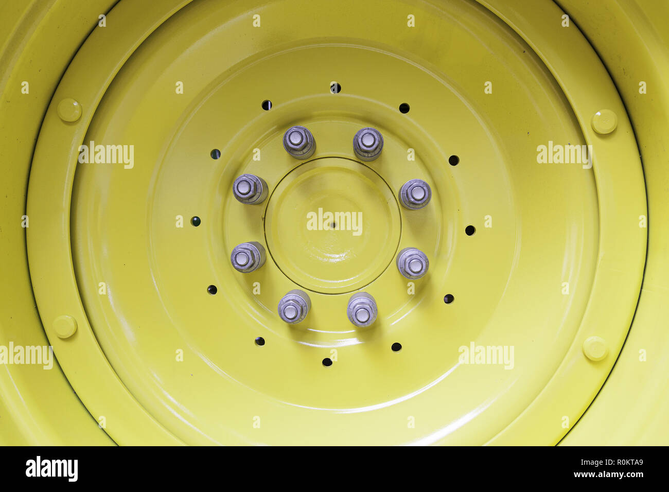 Yellow metal rim, detail of part of a new wheel, sturdy metal screws ...