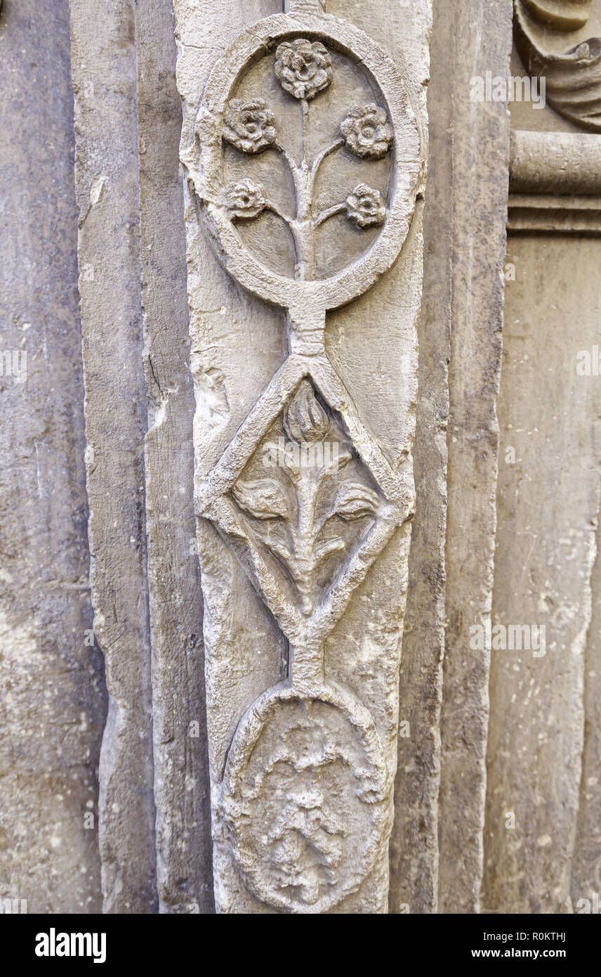Symbols carved in stone, detail of a wall decorated with medieval ...