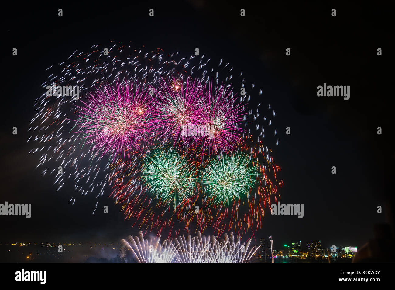 Explosion of colorful firecrackers in night sky Stock Photo - Alamy