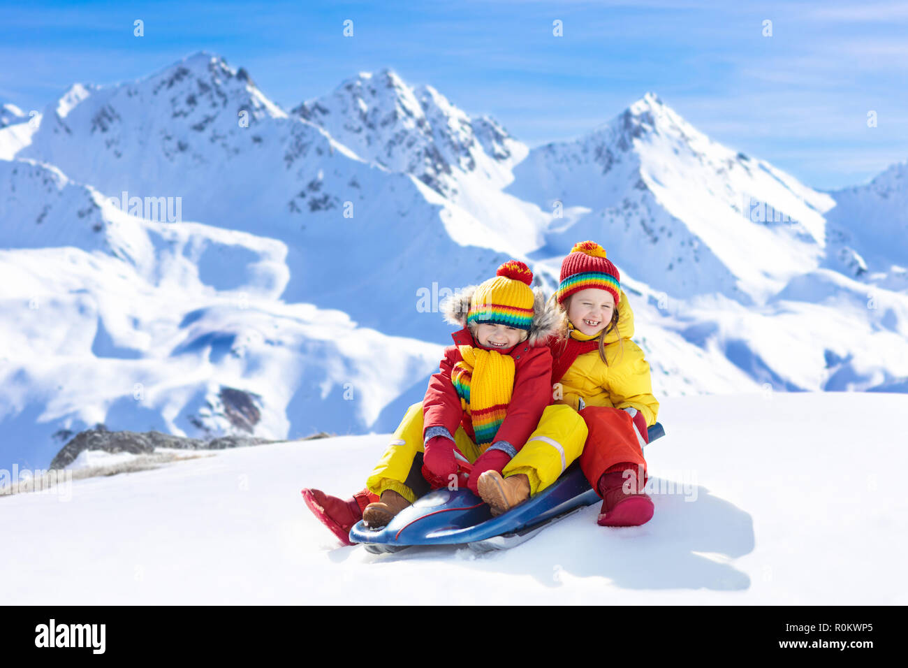 Little girl and boy enjoying sleigh ride. Child sledding. Toddler kid ...