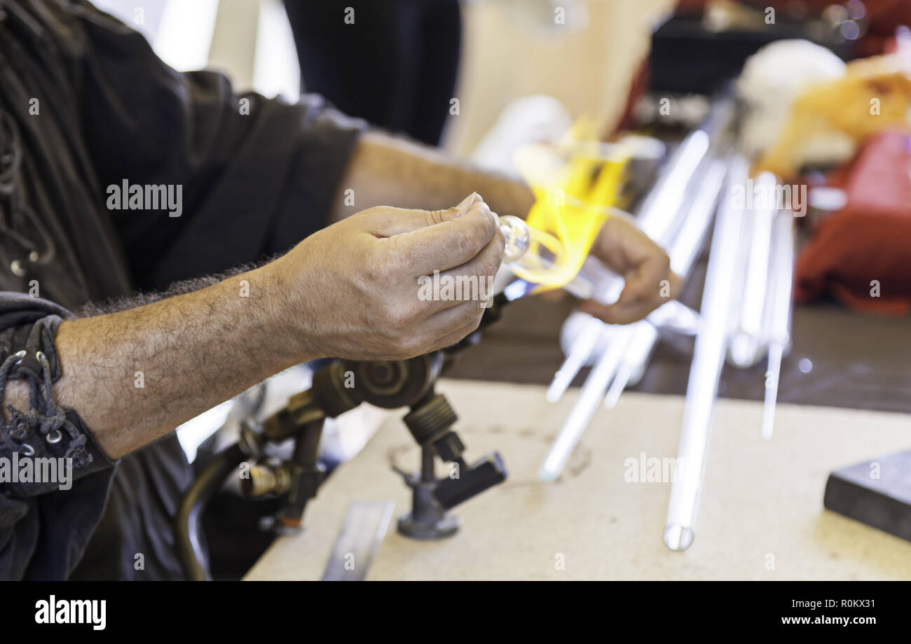 Artisan glass, detail of manual worker working with molten glass, craft ...
