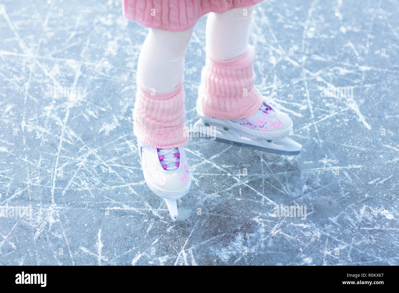 Child skating on natural ice on sunny winter day. Kids with skates ...