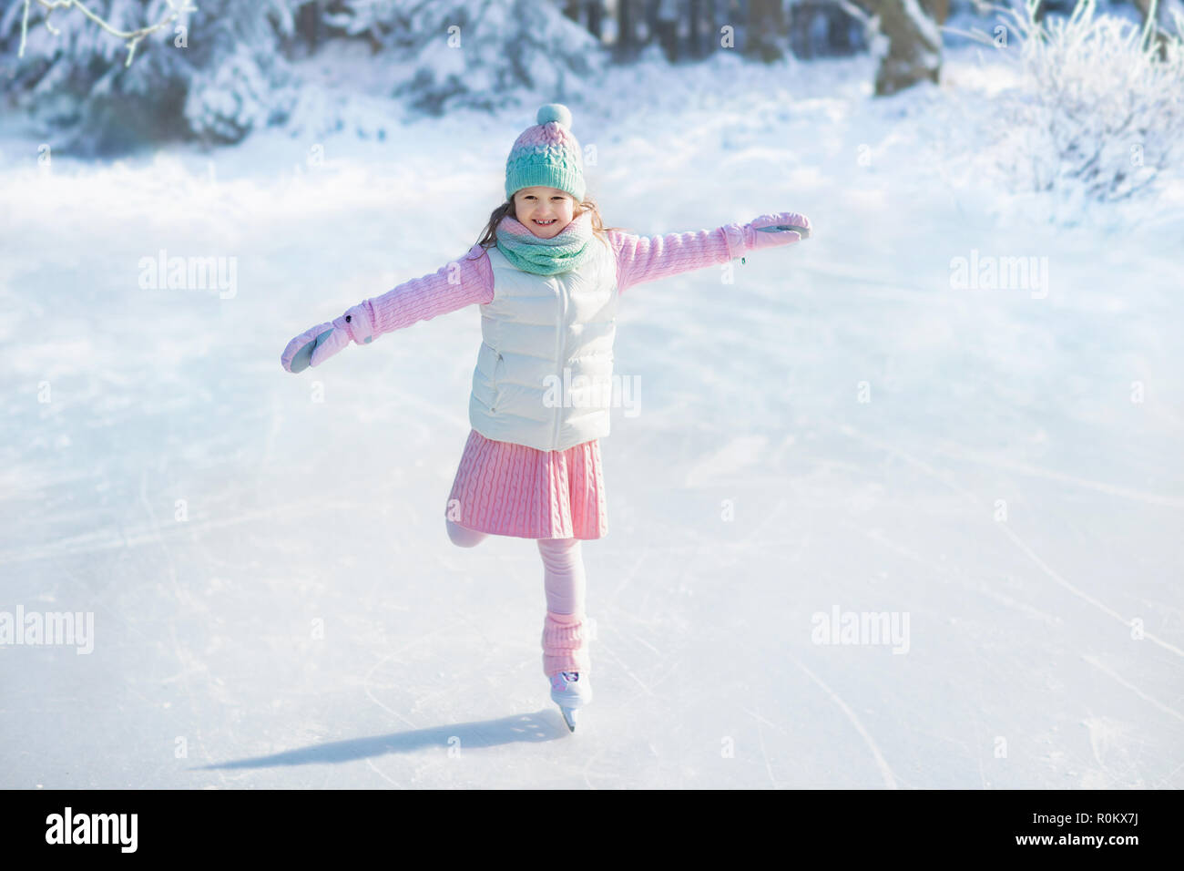 Child skating on natural ice on sunny winter day. Kids with skates ...