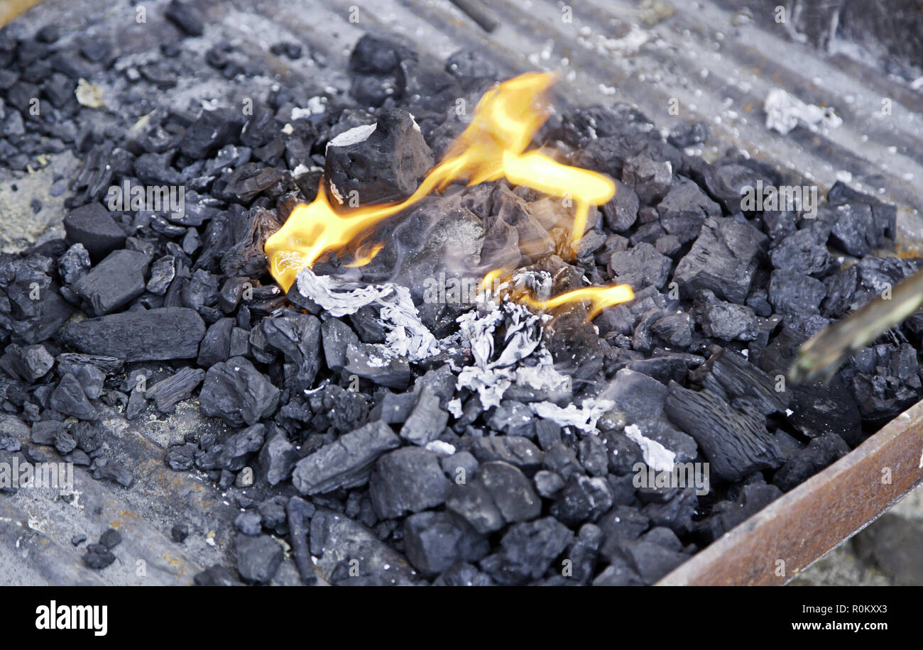 Embers of coal with fire, detail of a grill for grilling meat, ancient ...