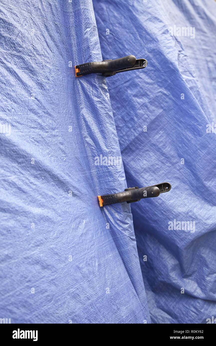 Blue fabric with tweezers, detail of a blue fabric background texture ...