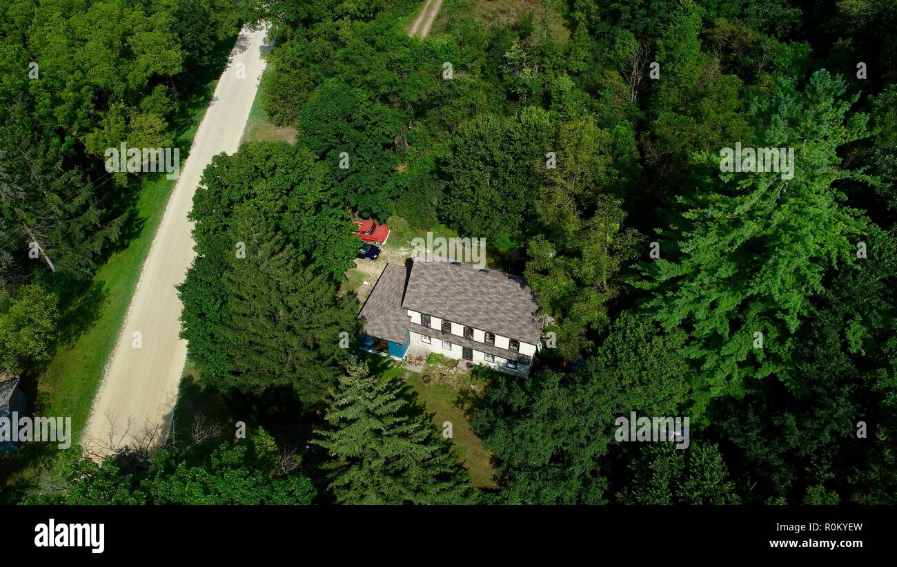 Aerial view of woods forests along Zumbro River, with old white house ...