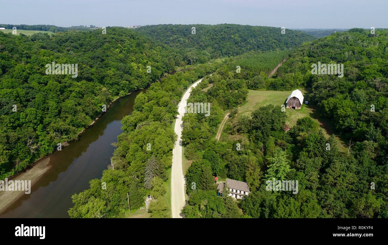 Aerial view of woods forests along Zumbro River, with old white house ...