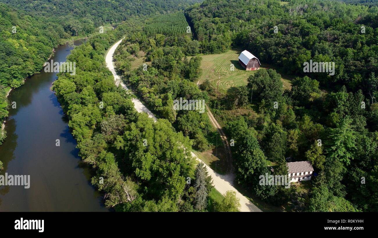 Aerial view of woods forests along Zumbro River, with old white house ...