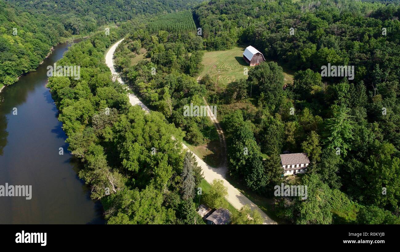 Aerial view of woods forests along Zumbro River, with old white house ...