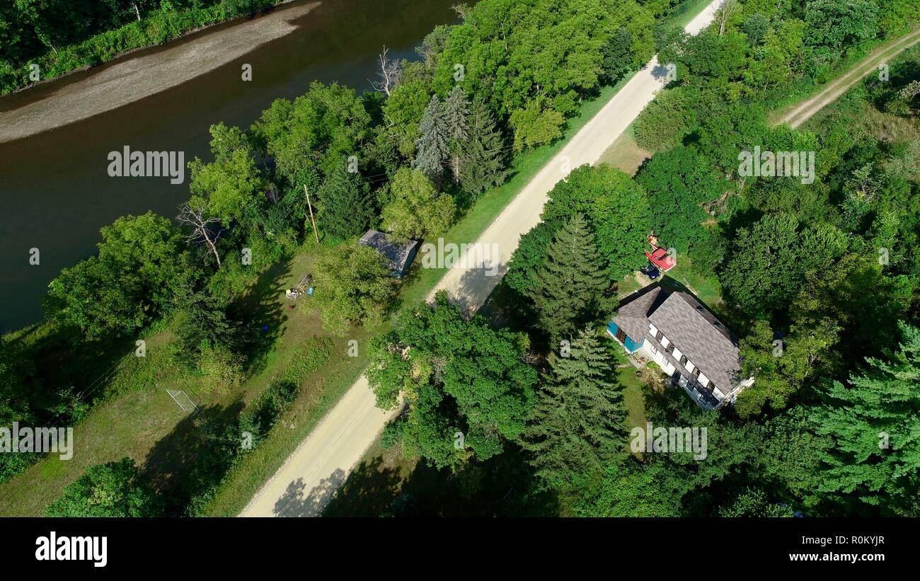 Aerial view of woods forests along Zumbro River, with old white house ...