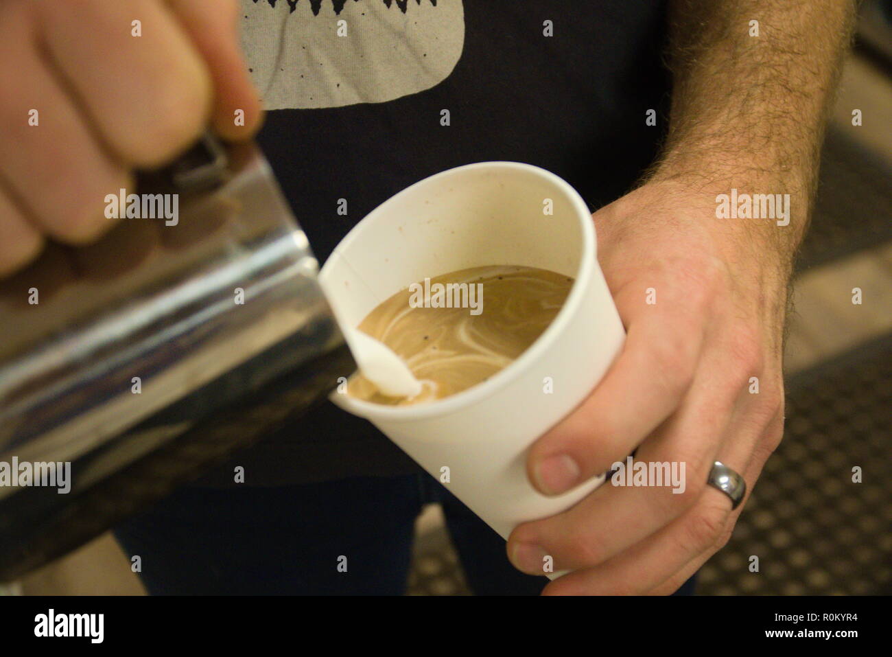 A barista pours steamed milk into a coffee Stock Photo - Alamy