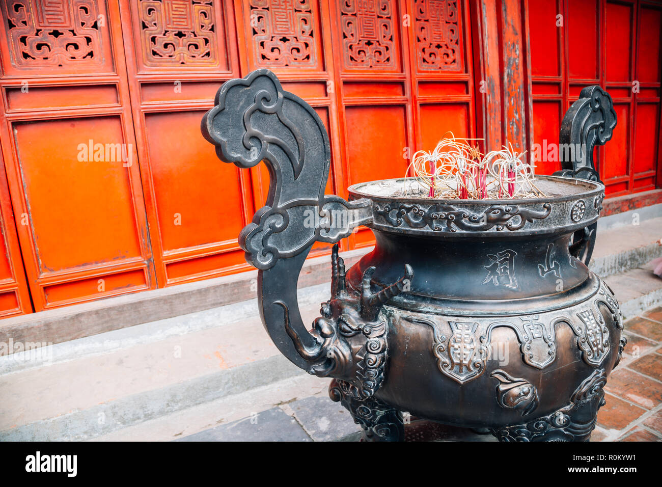 Incense and traditional building at Den ngoc son temple in Hanoi ...