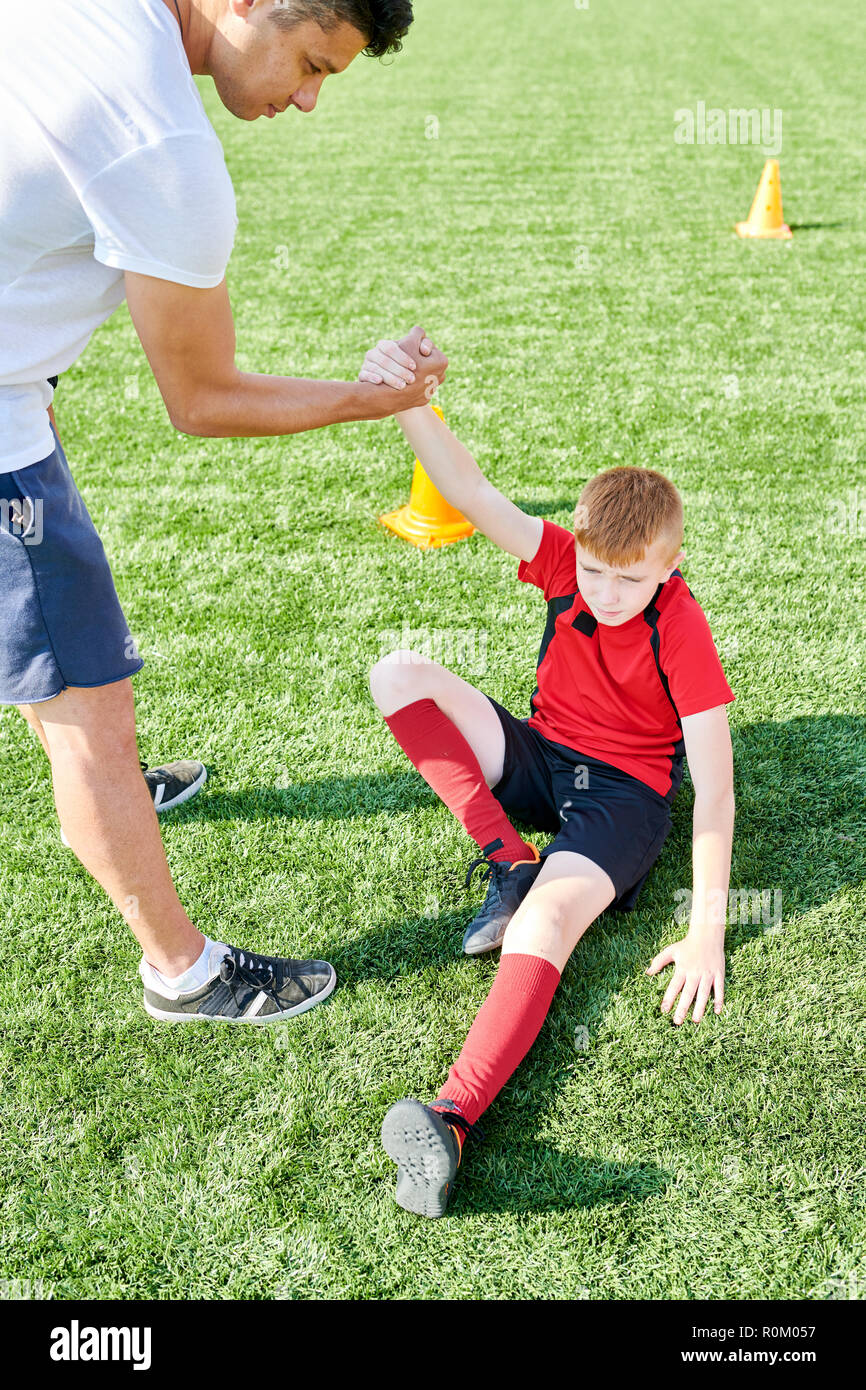 Coach Helping Boy Stock Photo - Alamy