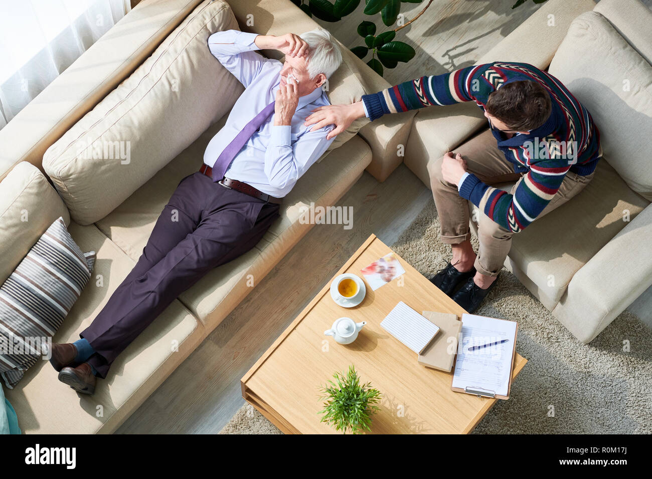 Elderly businessman crying at therapy session Stock Photo - Alamy