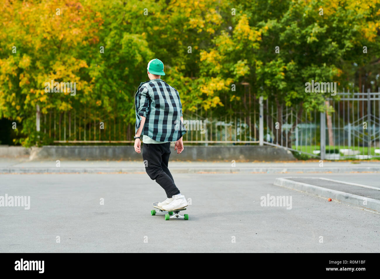 Young Man Skating Back View Stock Photo - Alamy