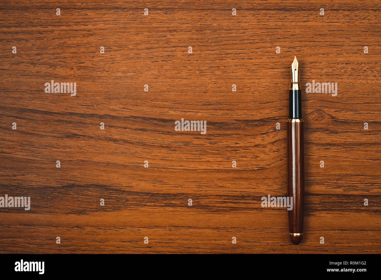 Fountain pen or ink pen on wooden working table with copy space, office ...