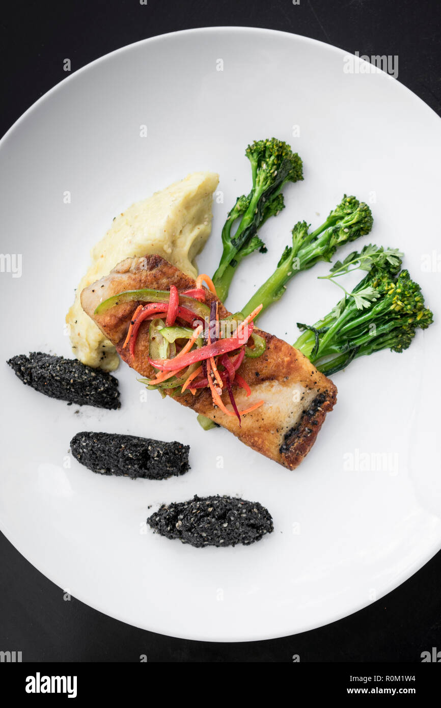 red snapper fish fillet with vegetables and black rice with black ...