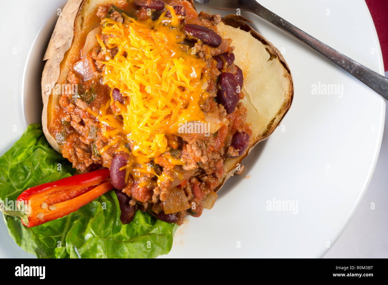 Oven baked jacket potato with a minced Beef Chili filling topped with ...