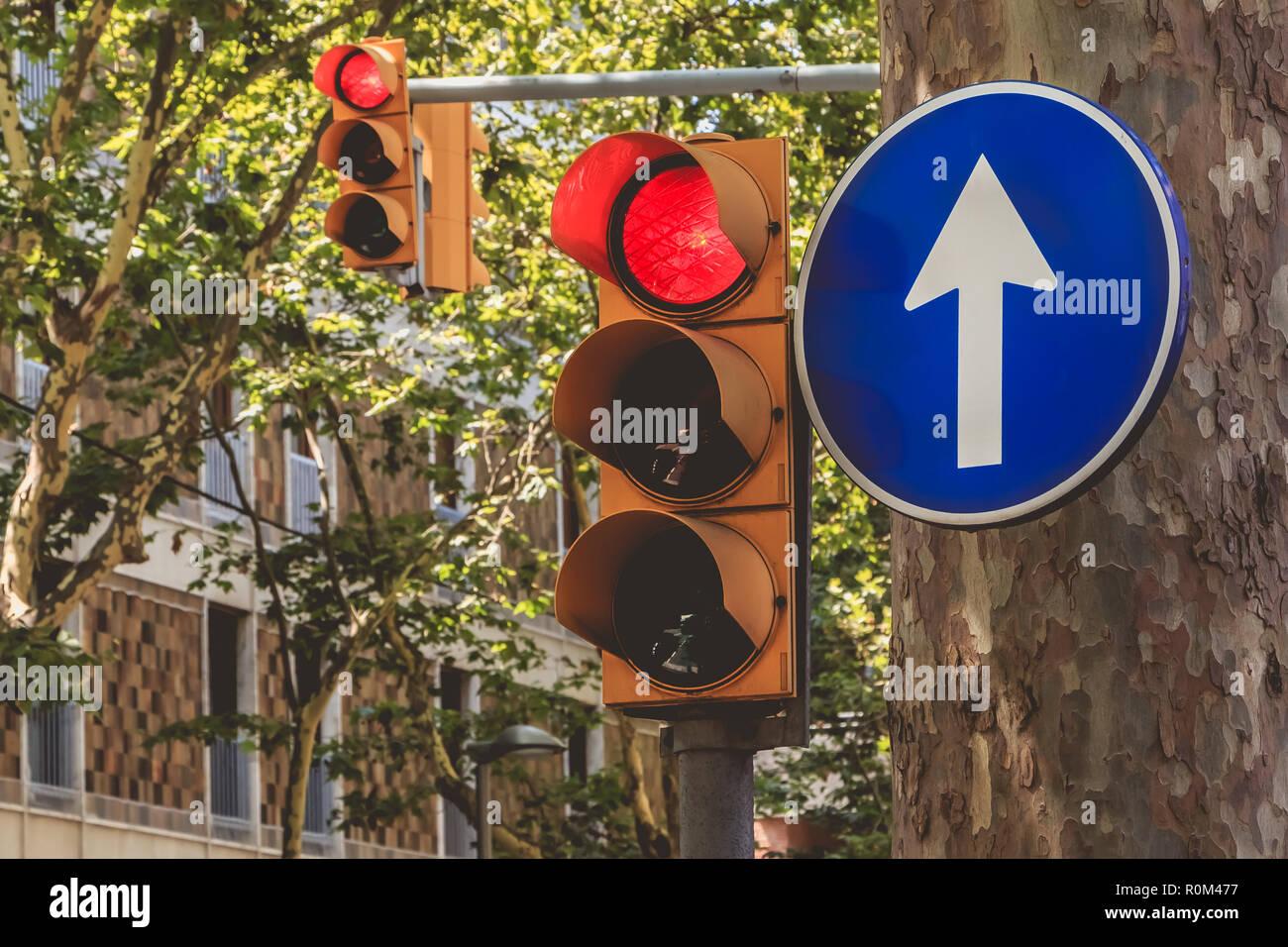 two red semaphore and a blue sign of obligation to go in front Stock ...