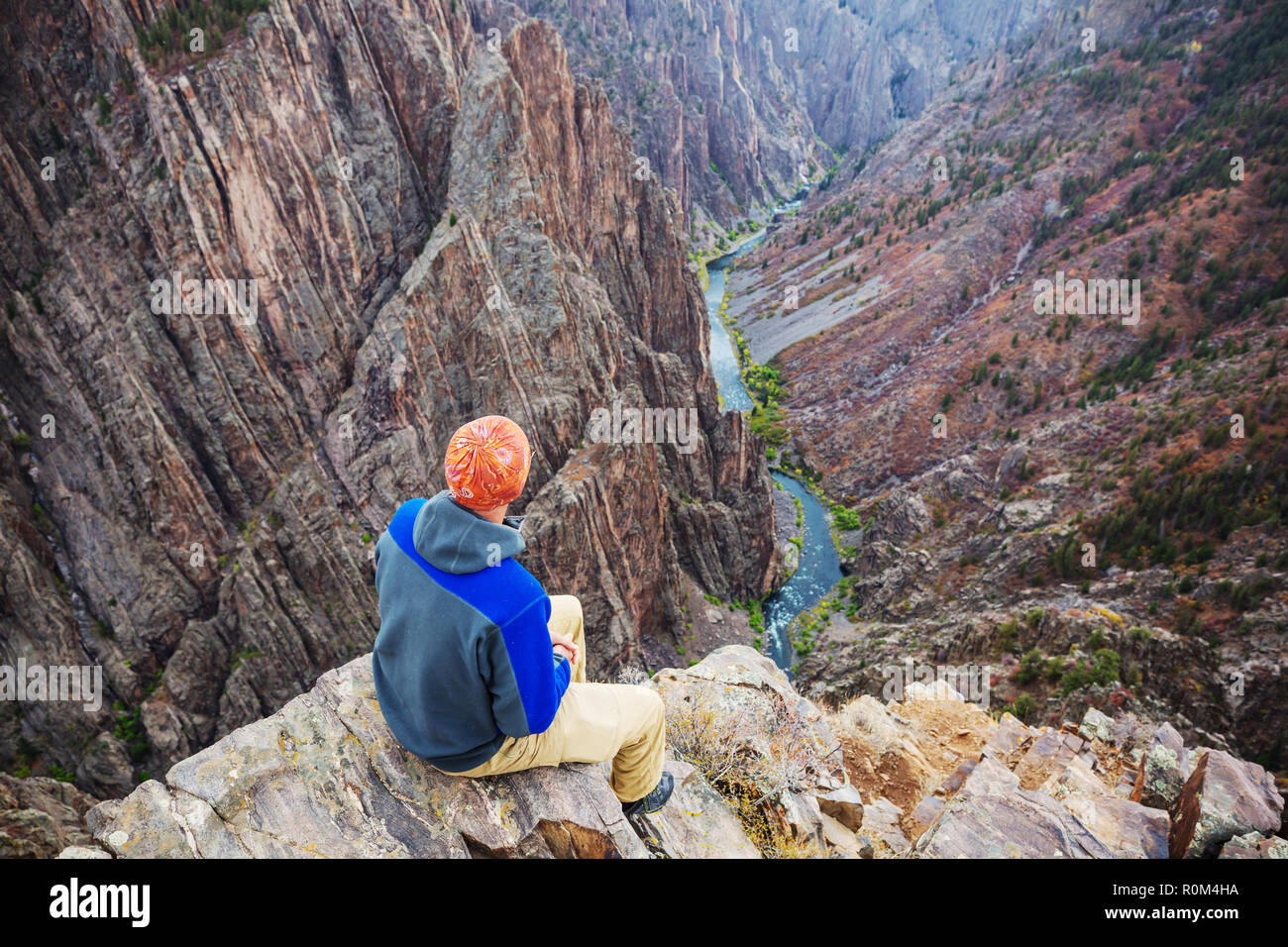 Tourist on the granite cliffs of the Black Canyon of the Gunnison ...