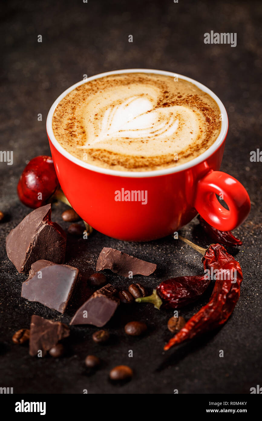 Chili and chocolate flavored coffee on dark background Stock Photo - Alamy